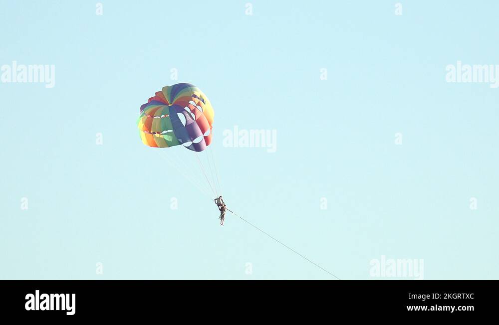 4K Tourist person glide parachute over sea dangerous parasailing ...