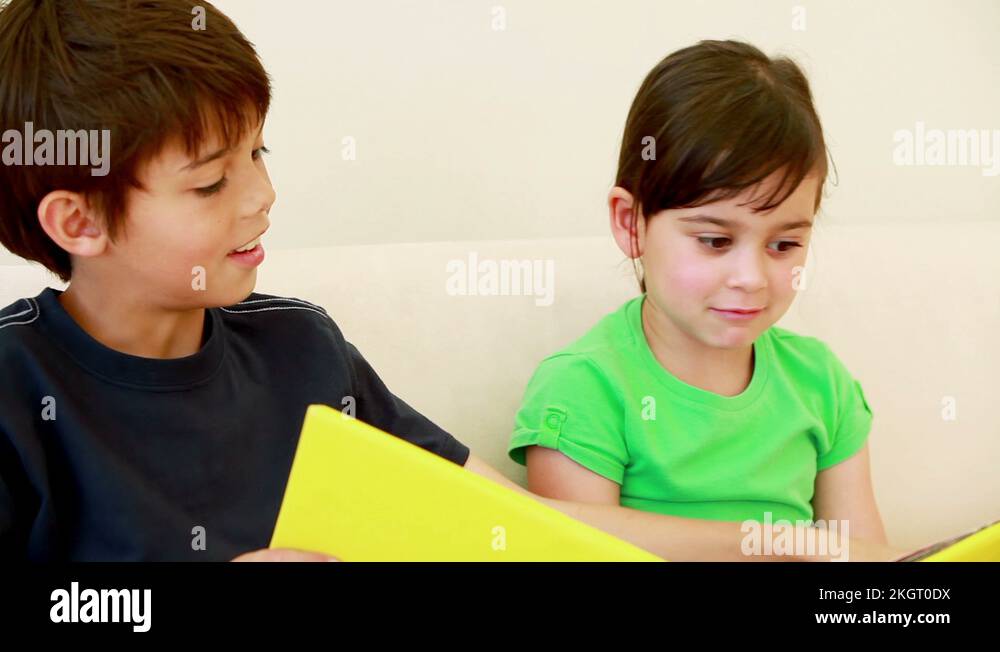 Brother and sister reading book together Stock Videos & Footage - HD ...