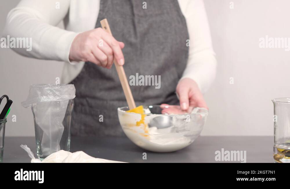 Mixing in food coloring into the royal icing to decorate sugar cookies ...