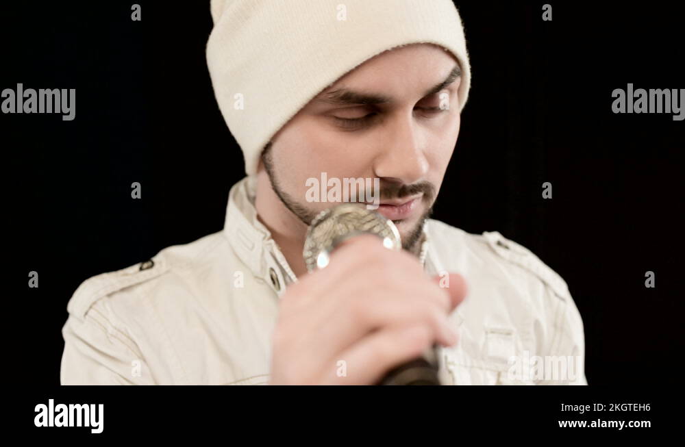 Close-up Frontman vocalist rock pop with a stylish beard in white ...