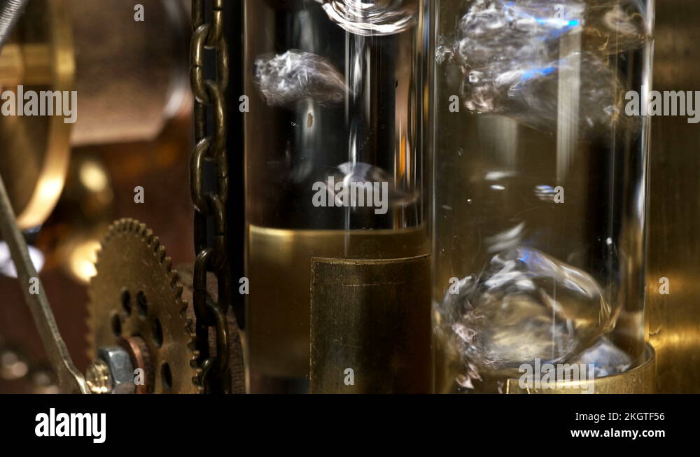 a device with rotating gears and two glass flasks filled with water, in ...
