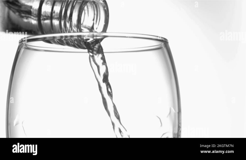 Trickle of water in a super slow motion flowing of the glass bottleneck ...