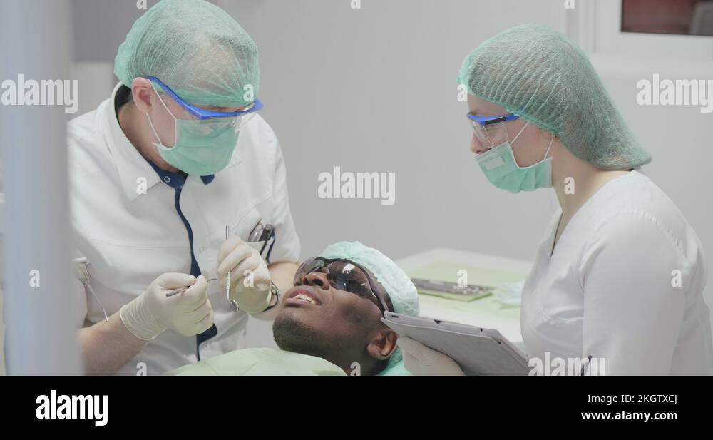 black patient open mouth for dental examination Stock Video Footage - Alamy