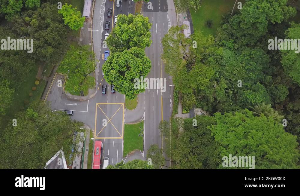 Top-down view of a uniquely shaped pedestrian bridge above a busy road ...