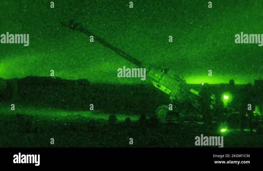 Night vision imagery of soldiers firing M777 Howitzer at known enemy ...