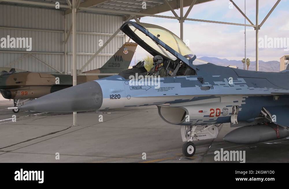 Canopy closing on pilot of F-16 Aggressor with new paint scheme Stock ...