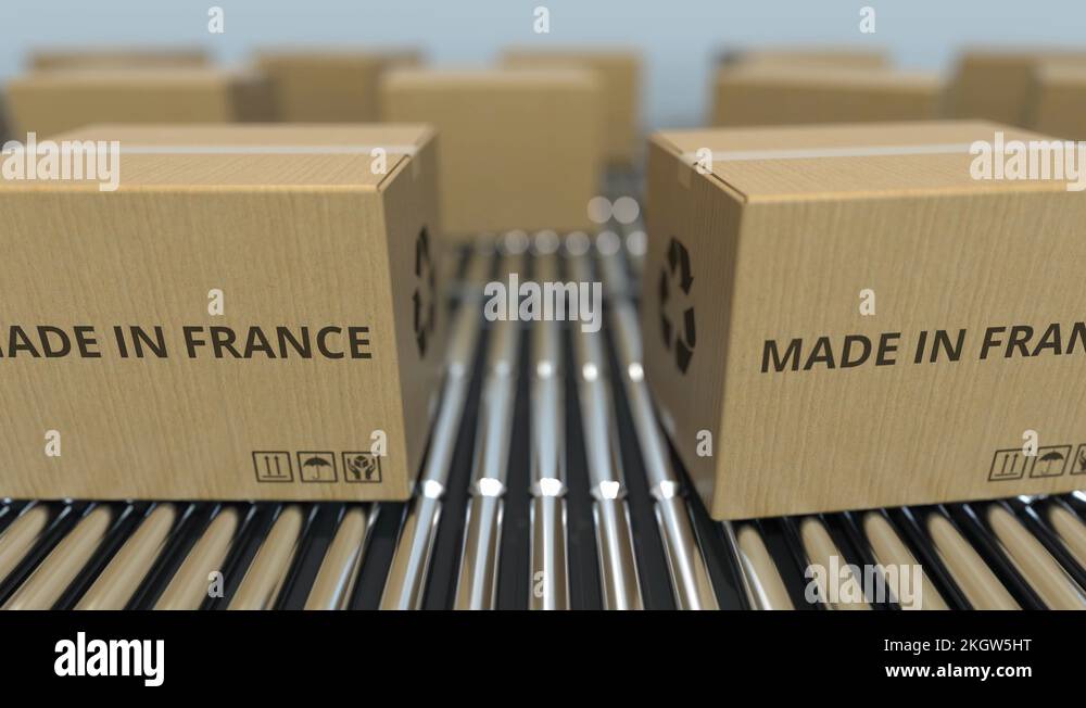 Boxes with MADE IN FRANCE text on roller conveyor. French goods related ...