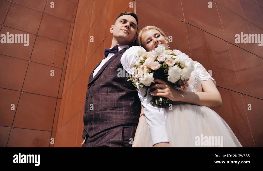 Girl with a bouquet in hand leaned on the shoulder of his boyfriend ...