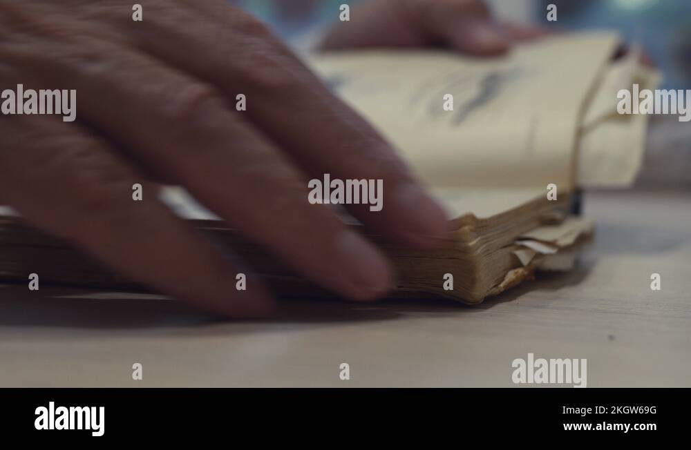 Man Leafing Through An Old Book On The Desk Stock Video Footage - Alamy