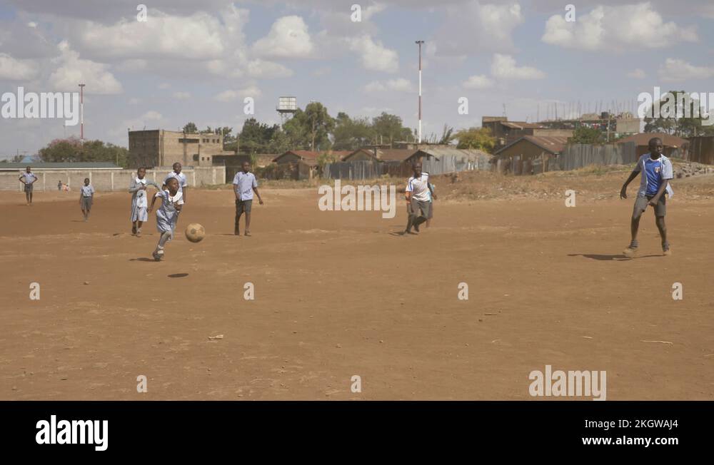 Kenyan school kids in uniform playing football playground, Kenya ...