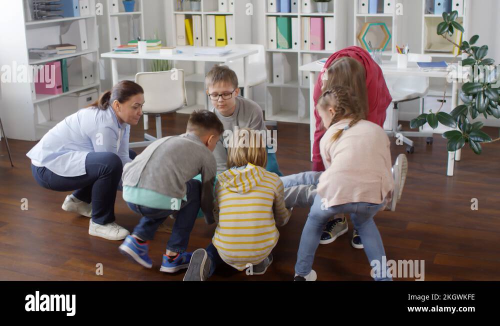 Kids Lifting Girl Up in Air during Relationship Building Workshop Stock ...