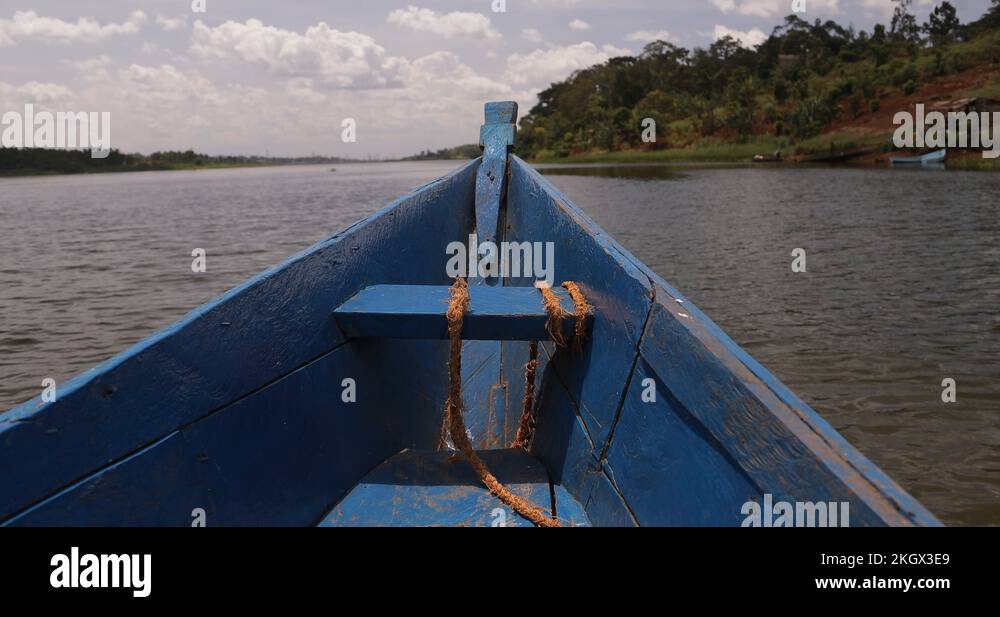 Sailing in a wooden boat at the source of the Nile in Jinja, Uganda ...
