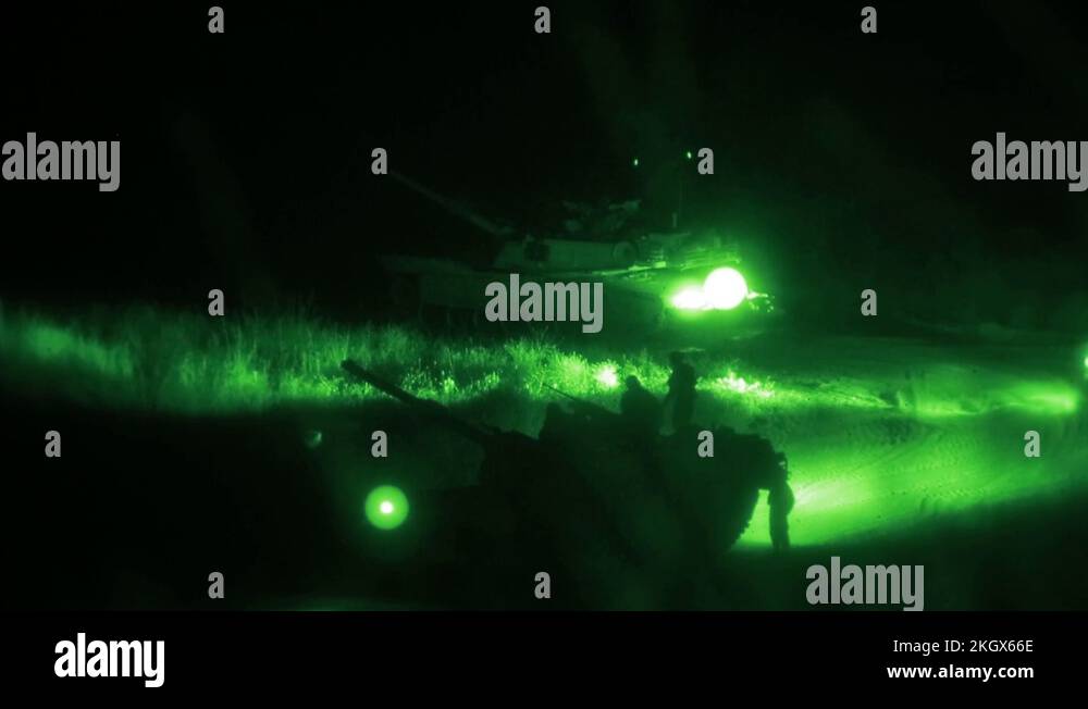 Night vision imagery of soldiers standing on top of M1A1 Abrams battle ...