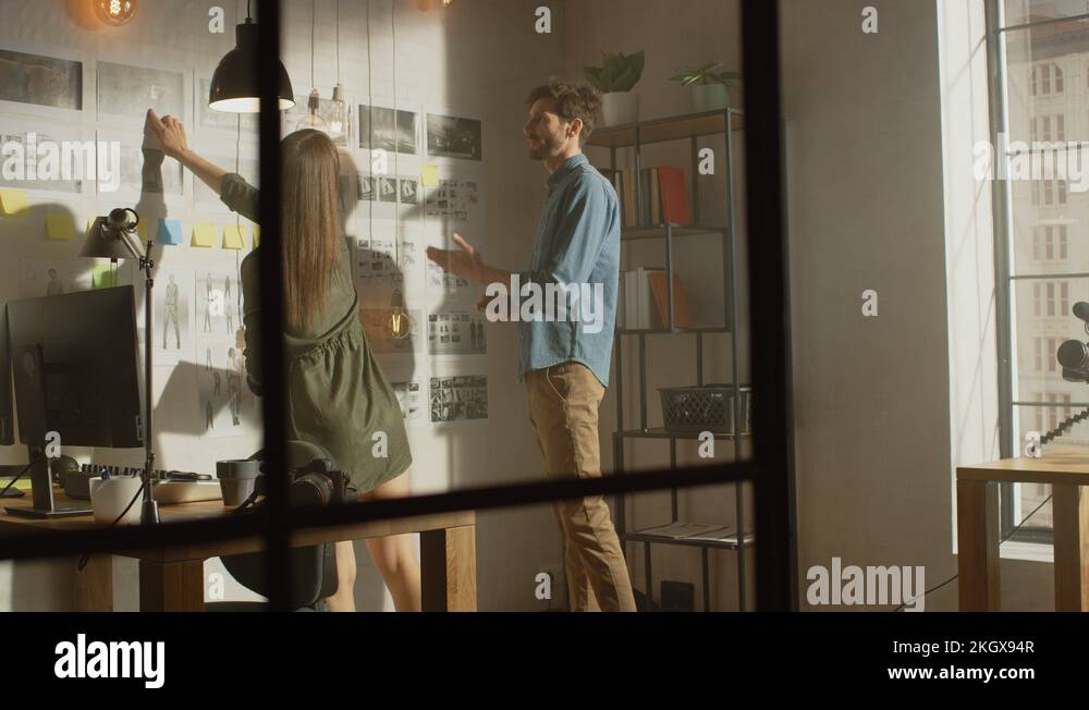 Young Creative Male and Female are Organizing a Storyboard on an Office ...