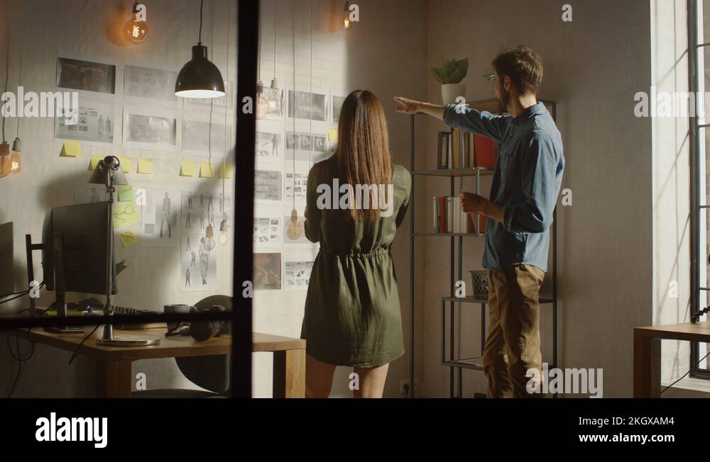 Young Creative Male and Female are Organizing a Storyboard on an Office ...