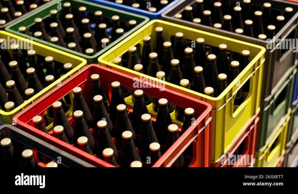 Loop of countless colorful beer crates stacked in an outdoor warehouse ...