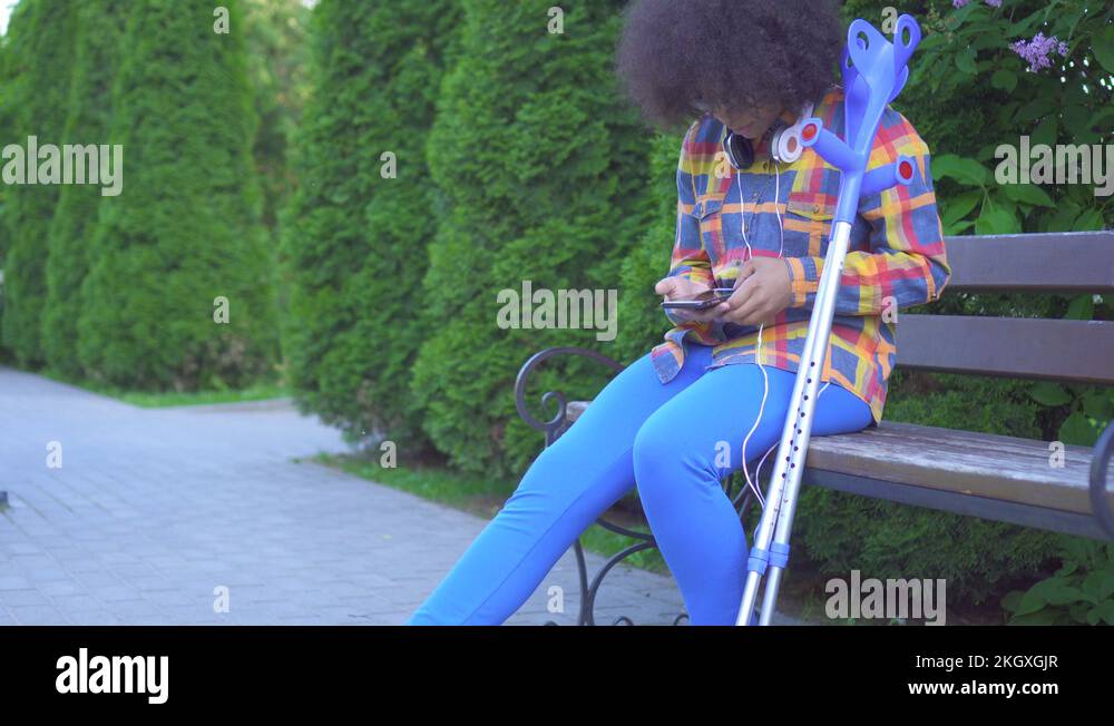 african american woman with an afro hairstyle with a broken leg with ...