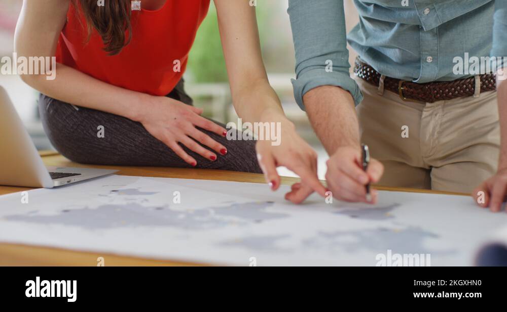 4K Business partners looking at world map, discussing strategy ...
