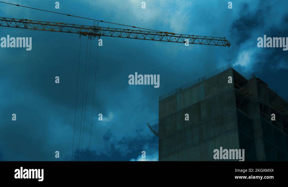 The concrete Industrial building near tall tower crane. Horror concept ...