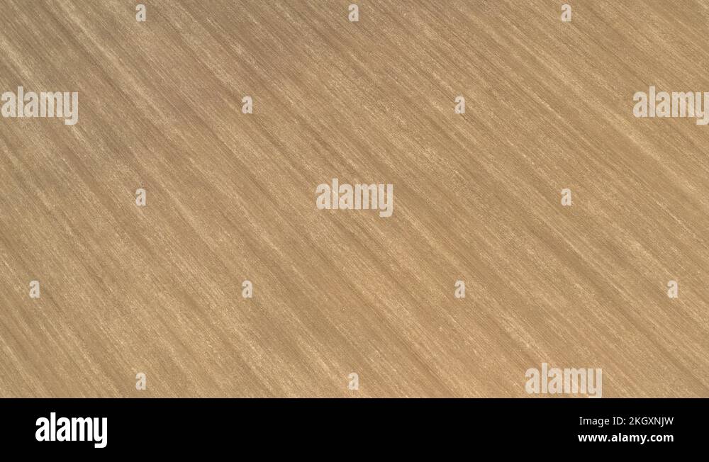 Parallel lines in earth made by tractor plough 4K aerial footage Stock ...