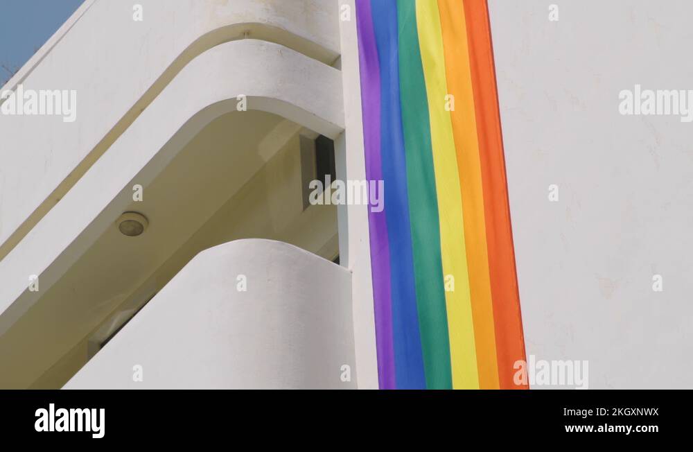Big vertical Gay Pride flag is hanging on a building in Tel Aviv ...