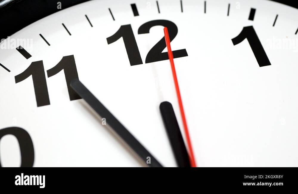 The Time On The Clock Twelve With The Black Arrow Running. Timelapse ...