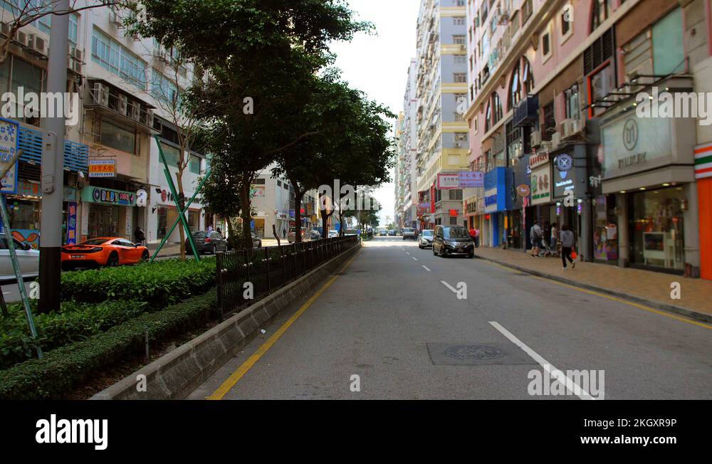 Two-way street, on the edges are tall buildings with signs of ...