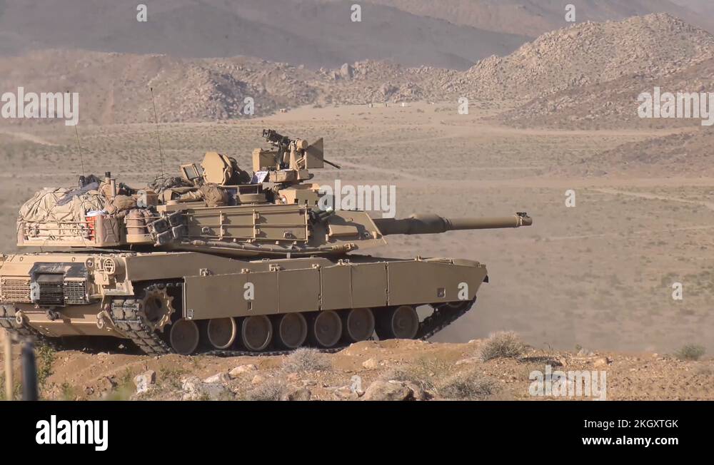 M1A2 Abrams battle tank reversing into position during live fire ...