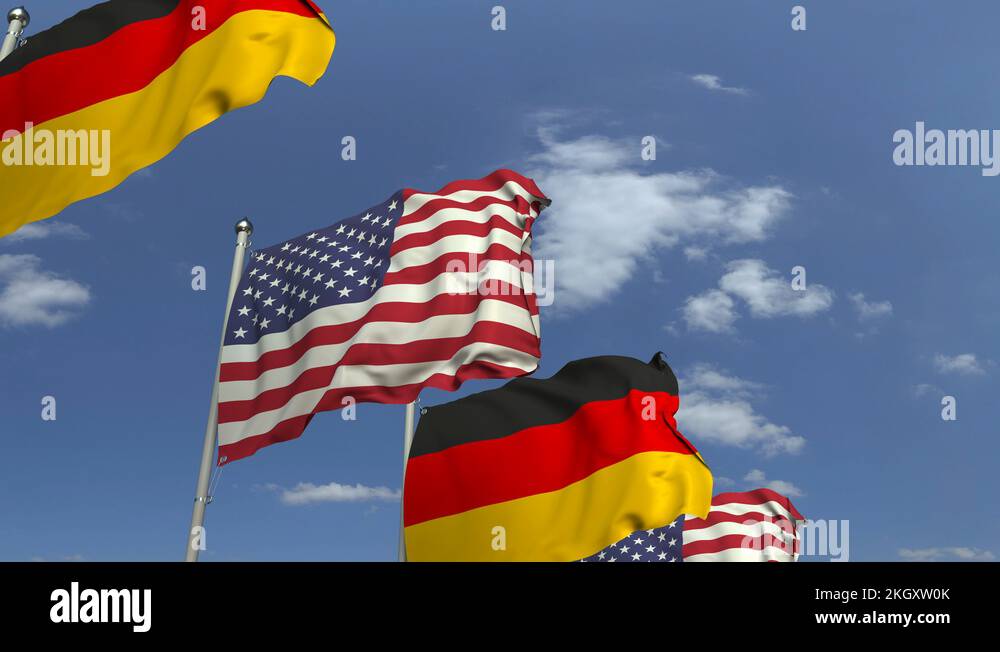 Waving flags of Germany and the USA on sky background, loopable 3D ...