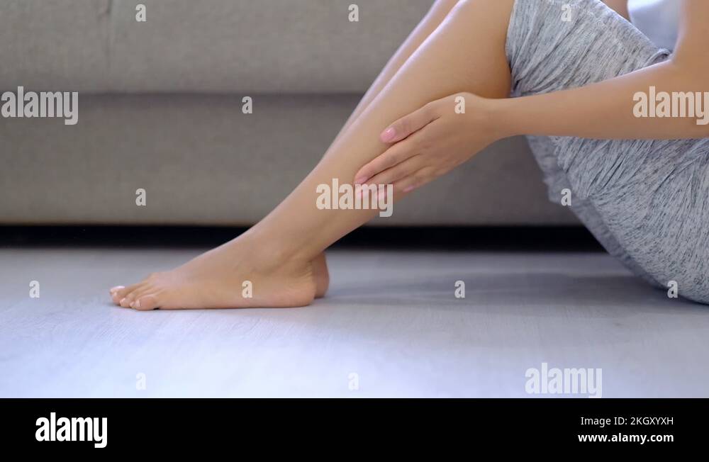 slow motion. Woman rubbing tired swollen feet, varicose veins. Female ...