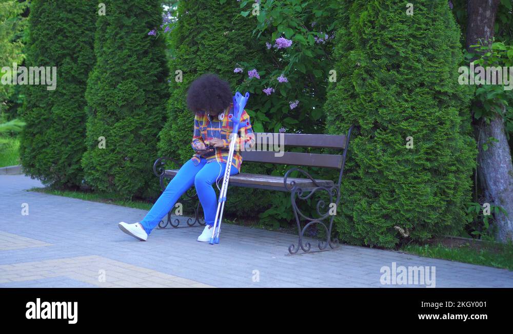 african american woman with an afro hairstyle with a broken leg with ...