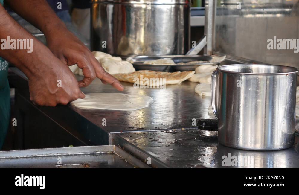 Male hands making traditional Indian food called 'Roti Canai'. 4k Stock ...