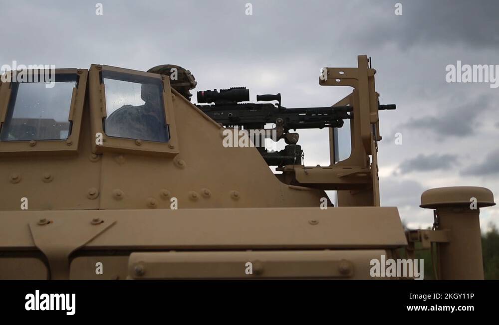 Soldier firing machine gun from armored vehicle during exercise Thunder ...
