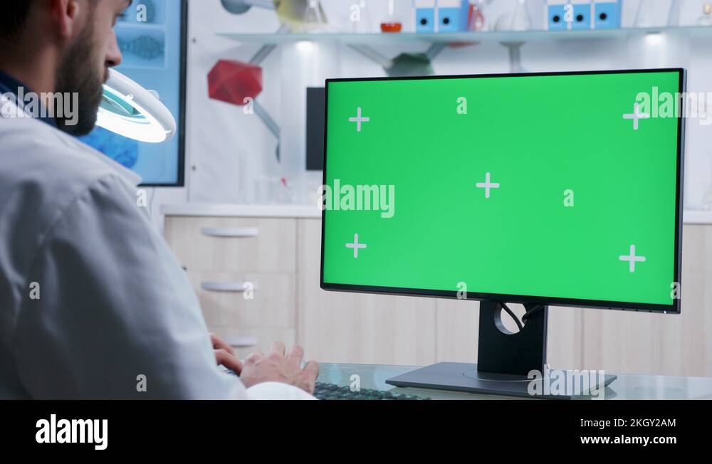 Researcher working on green screen mock-up PC in modern laboratory ...