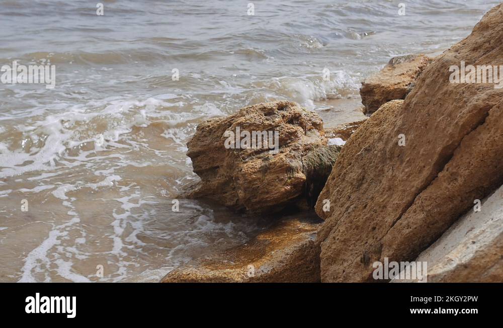 Tide and sea, beach and rock stones background. Sparkling ocean waves ...
