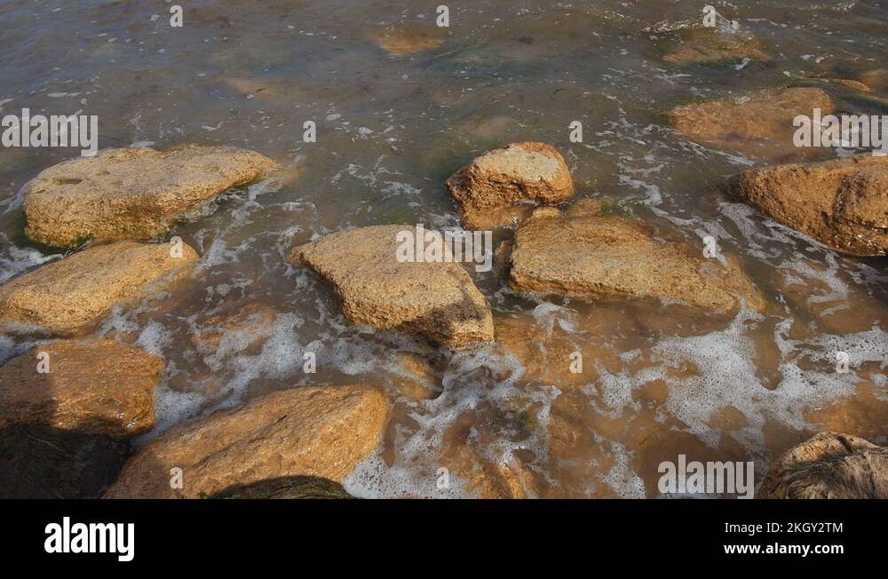 Tide and sea, beach and rock stones background. Sparkling ocean waves ...