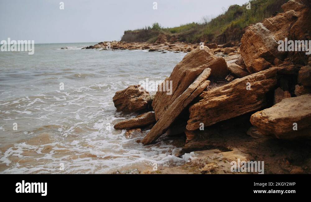 Tide and sea, beach and rock stones background. Sparkling ocean waves ...