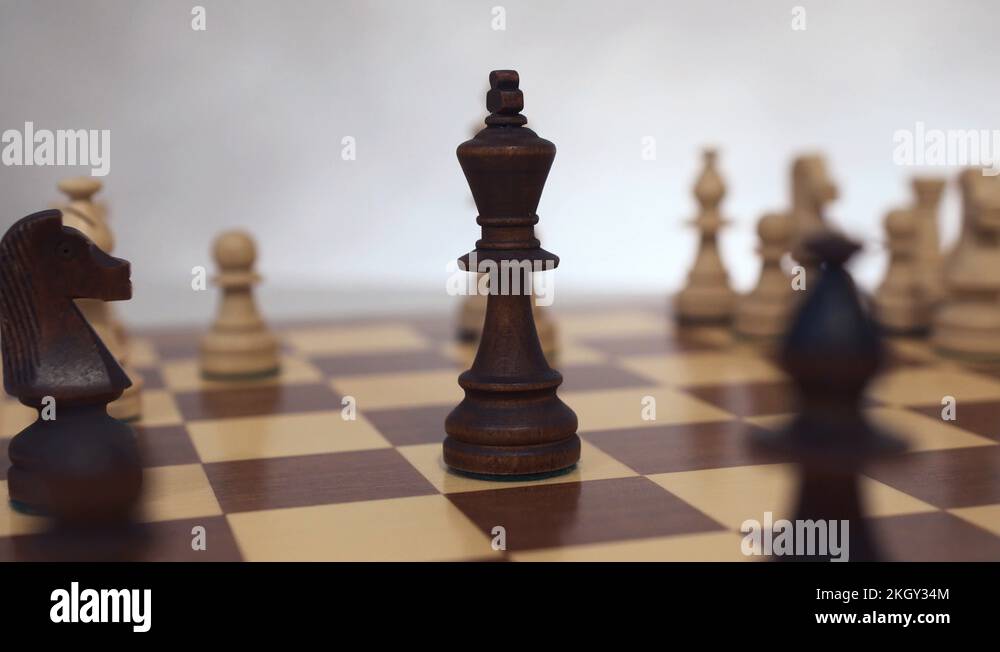 Checkmate. White queen beats black king. Chess board with classic wood ...