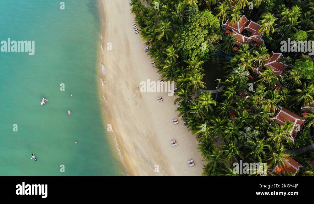 Blue lagoon and sandy beach with palms. Aerial view of blue lagoon and ...
