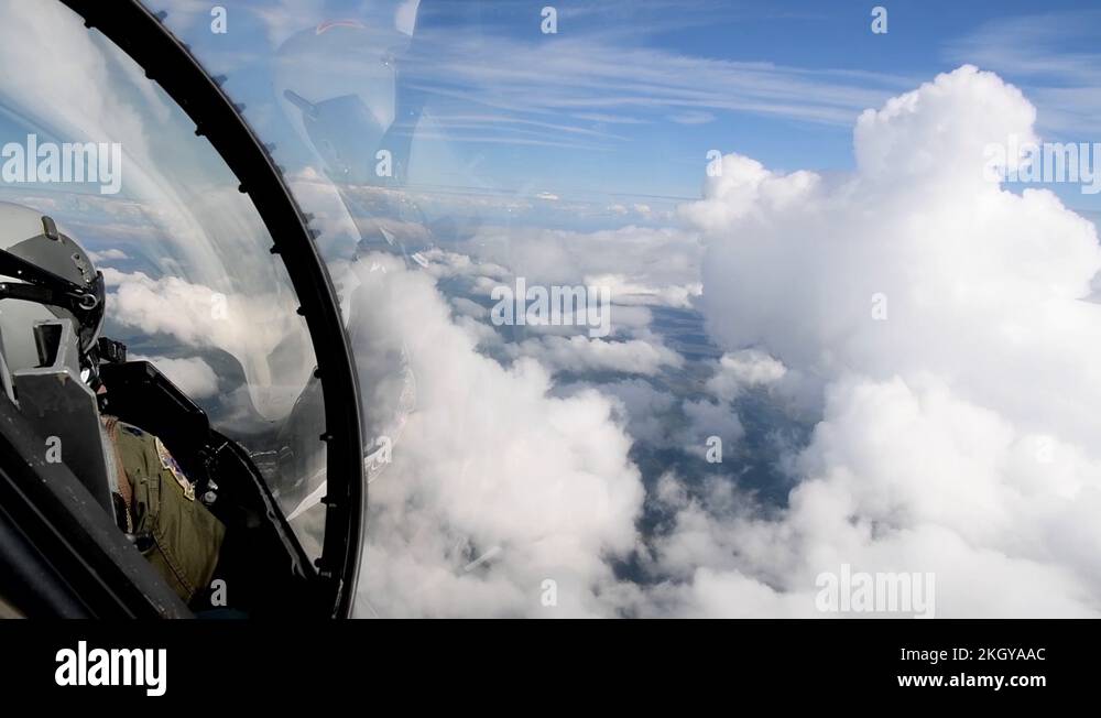 Cockpit footage of pilot flying F-16 Fighting Falcon above clouds Stock ...