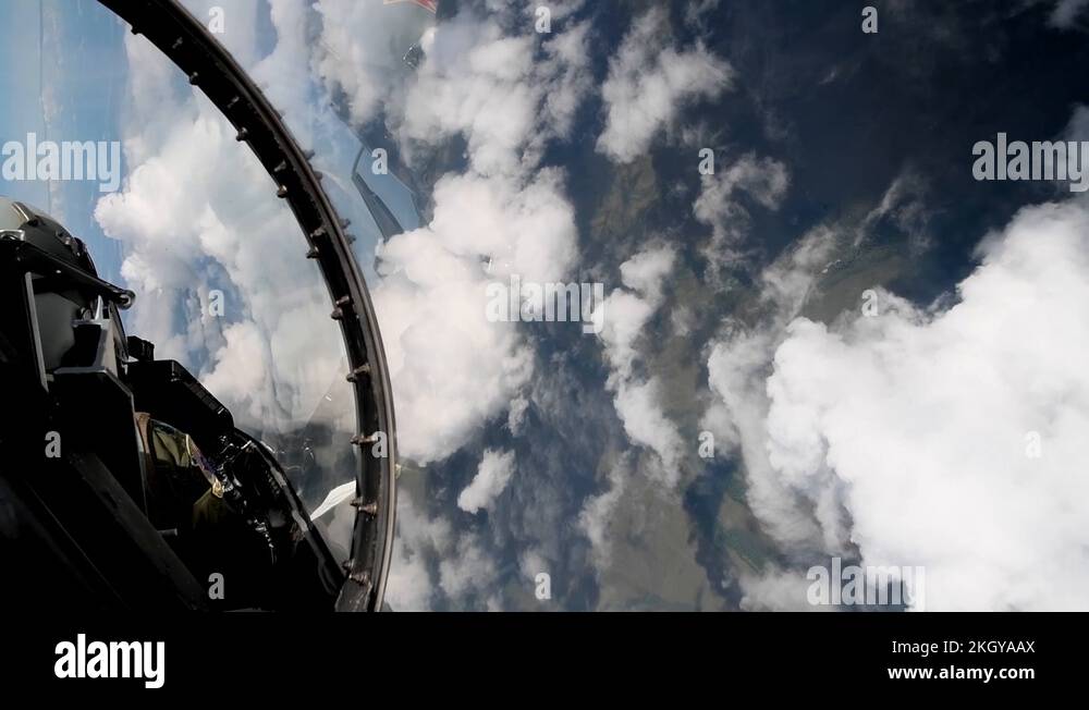 In-flight footage of pilot flying F-16 Fighting Falcon above clouds ...