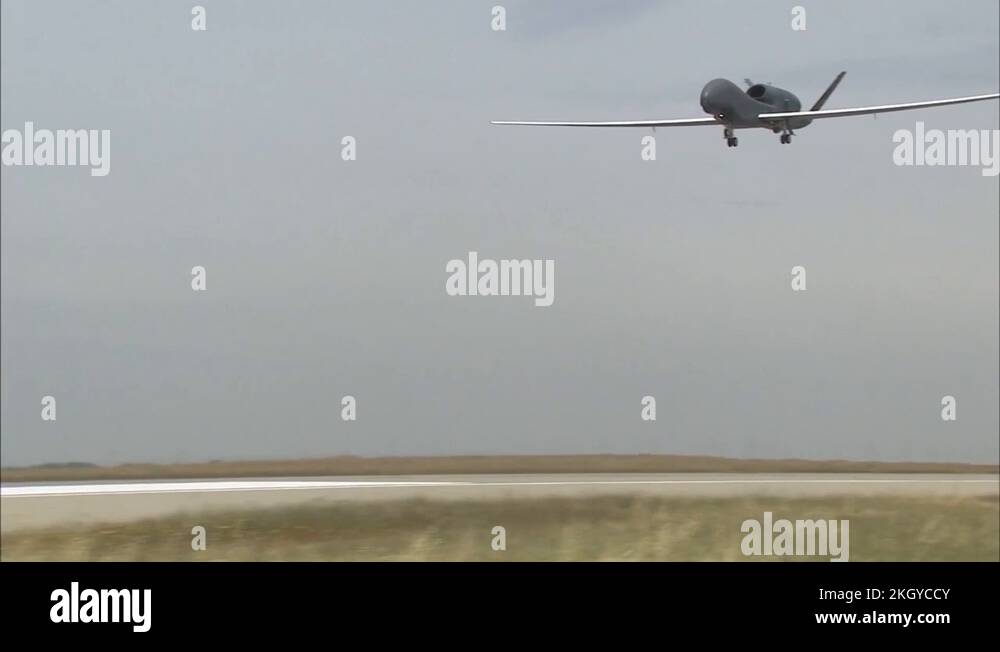 RQ-4 Global Hawk unmanned aerial vehicle landing on runway Stock Video ...