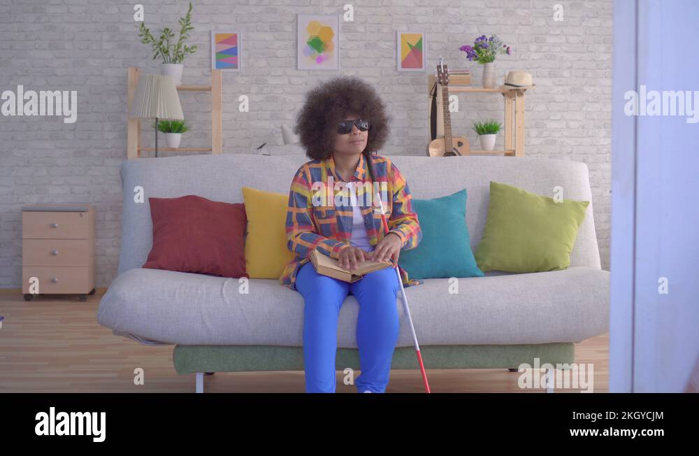 African american woman with an afro hairstyle visually impaired reading ...