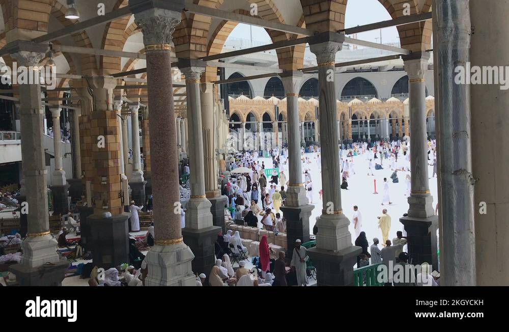 Left to right pan footage of Muslim pilgrims circumambulate (tawaf) the ...
