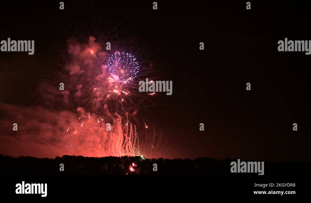 Dazzling large-scale fireworks with bright lights above the horizon ...