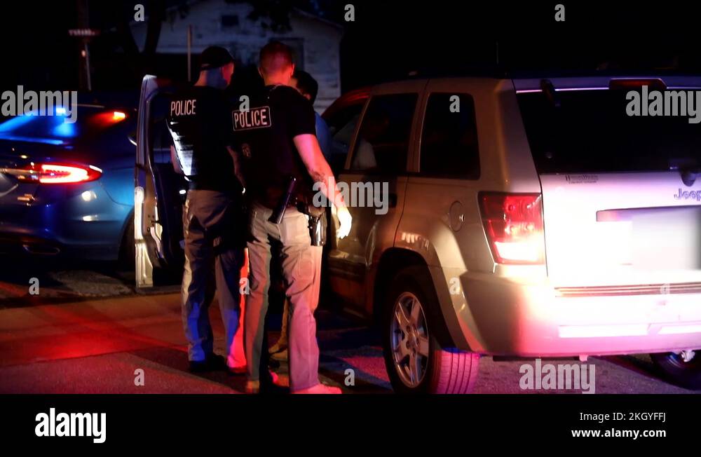 Police officers arresting criminal in vehicle Stock Video Footage - Alamy