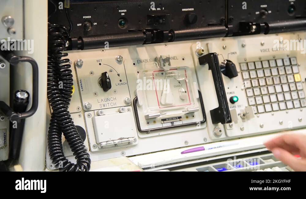 Missile combat crew member opening cover and turning switch on control ...