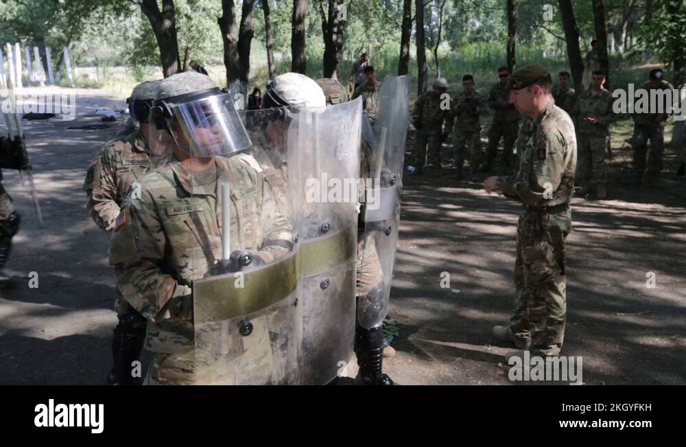 Soldiers form wall with riot shields during riot control training Stock ...