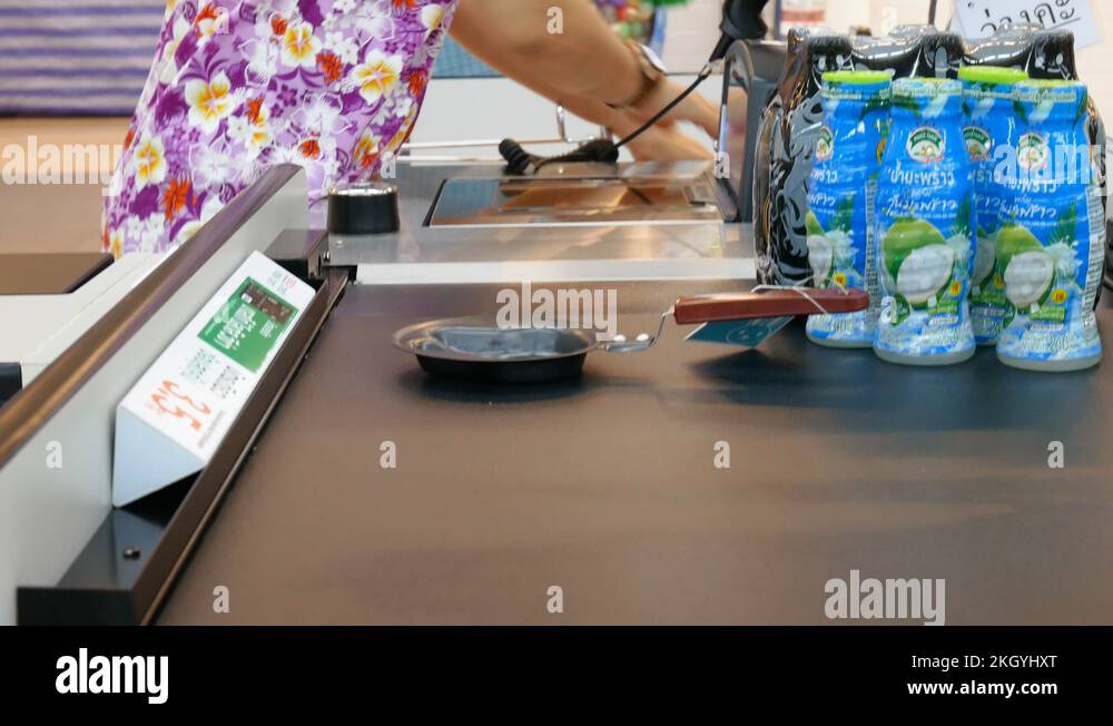 At the Supermarket:Checkout Counter Hands of the cashier scanning ...