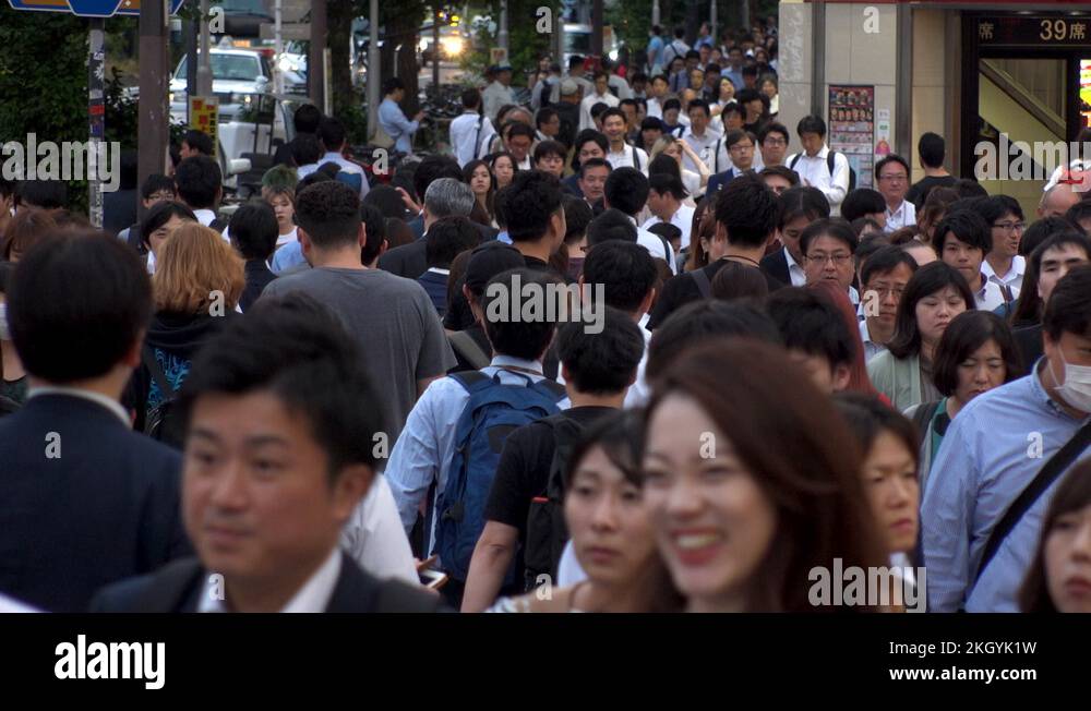 TOKYO, JAPAN : Crowd of people walking down the street in busy rush ...